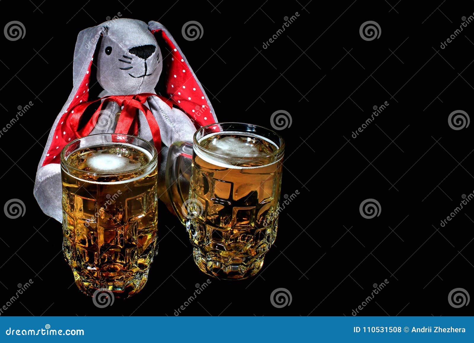 Easter Bunny with Two Mugs of Beer Against Black Background Stock Photo ...