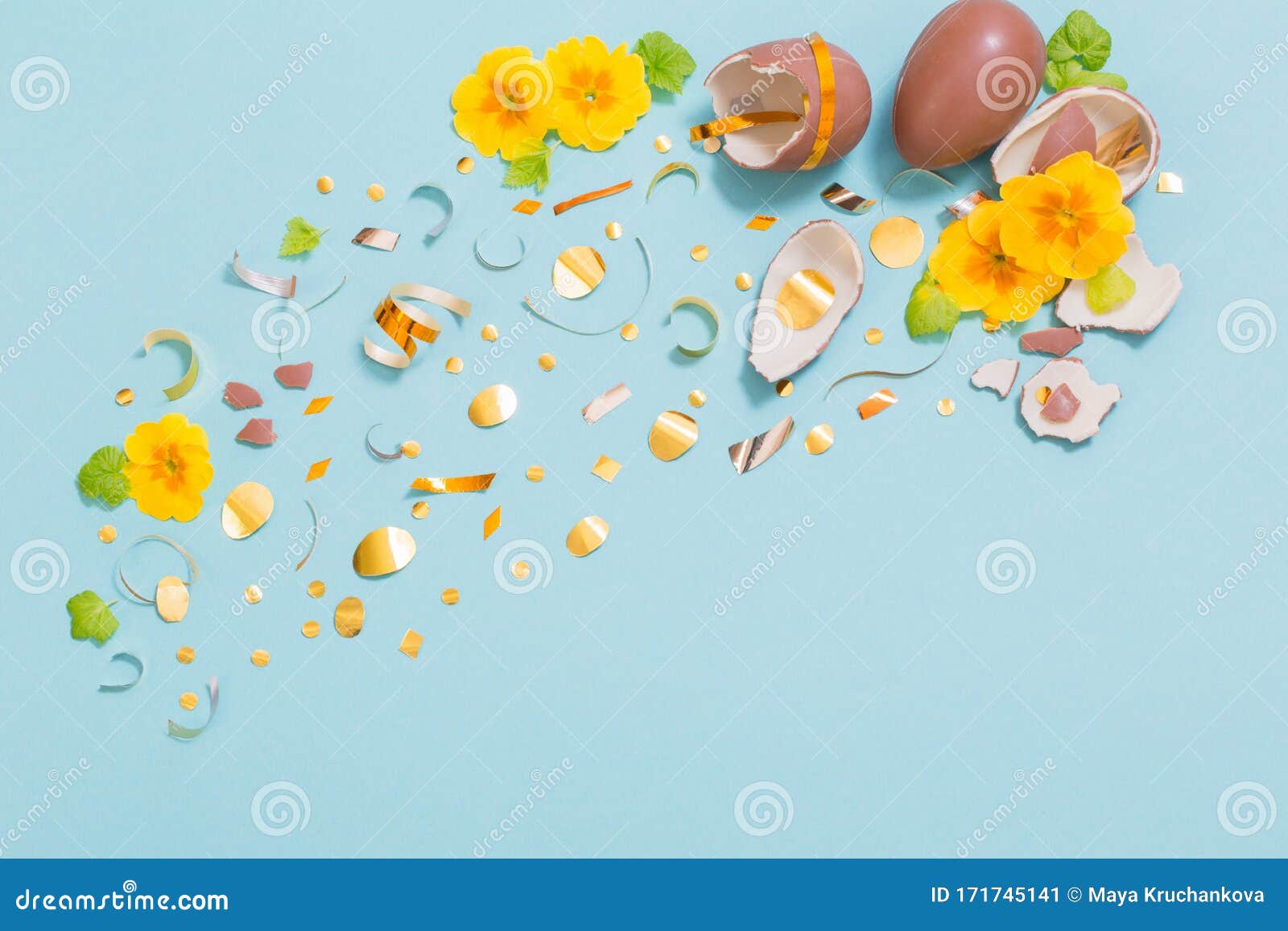 Easter Chocolate Egg with Confetti and Spring Flowers on Blue ...