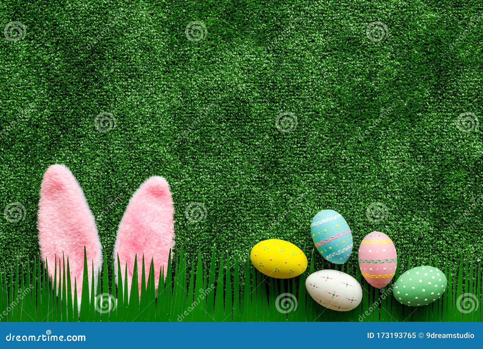 Easter Concept. Eggs, Bunny`s Ears on Green Grass Background Top-down ...