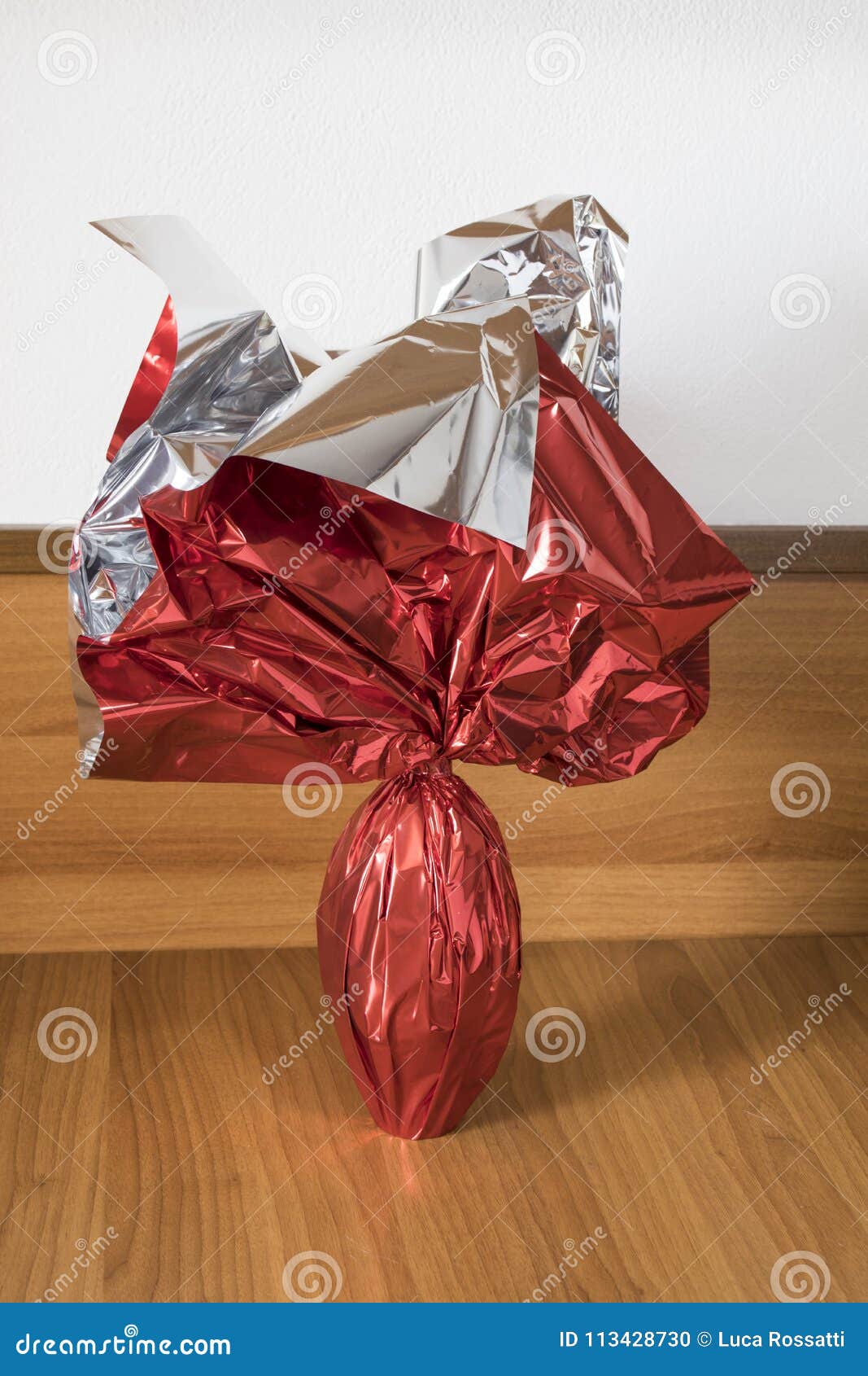 An Easter Egg Made of Chocolate in a Red Wrapping Paper Stock Photo ...