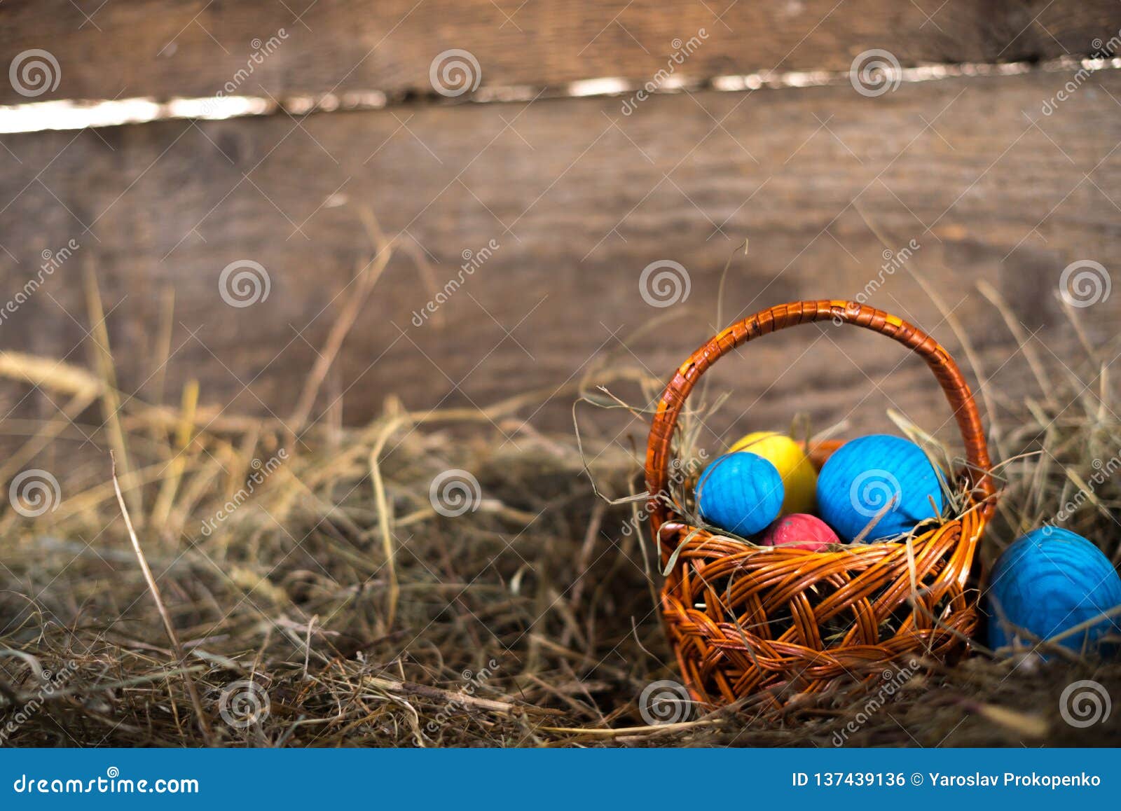 Easter Eggs in a Basket on a Hay with a Blurred Background Stock Photo ...