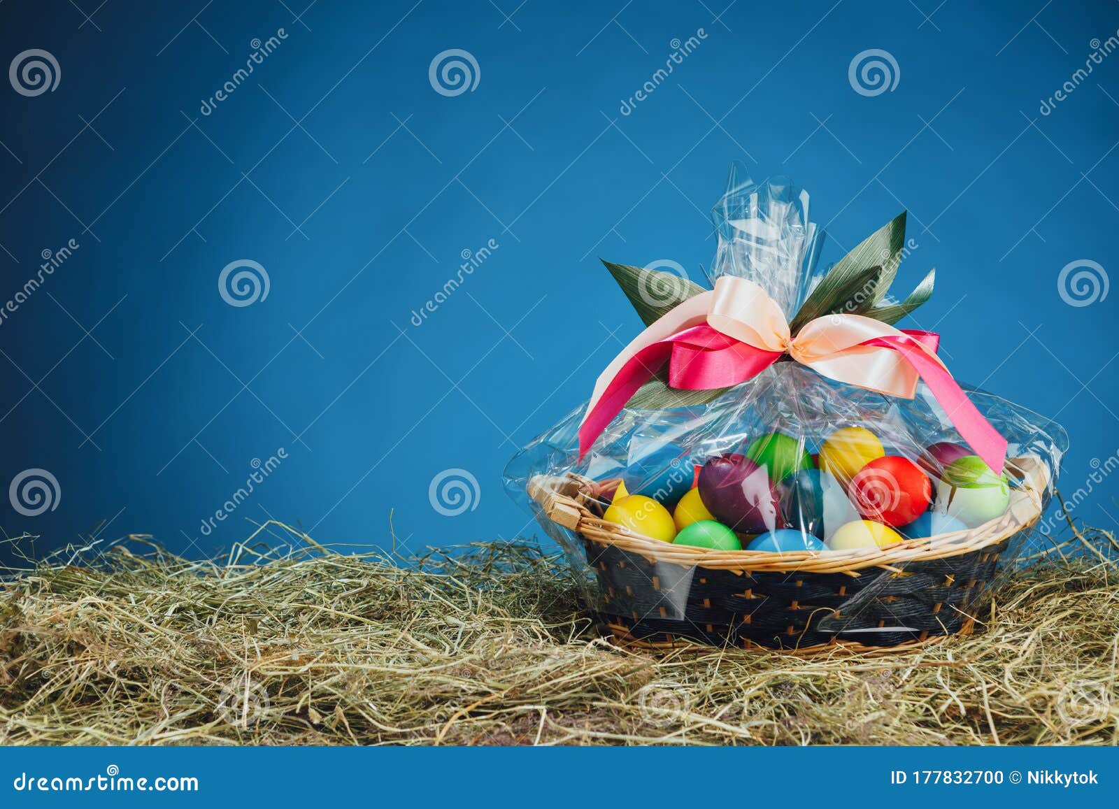 Easter Gift Basket with Multicolor Eggs, Blue Background Stock Photo ...