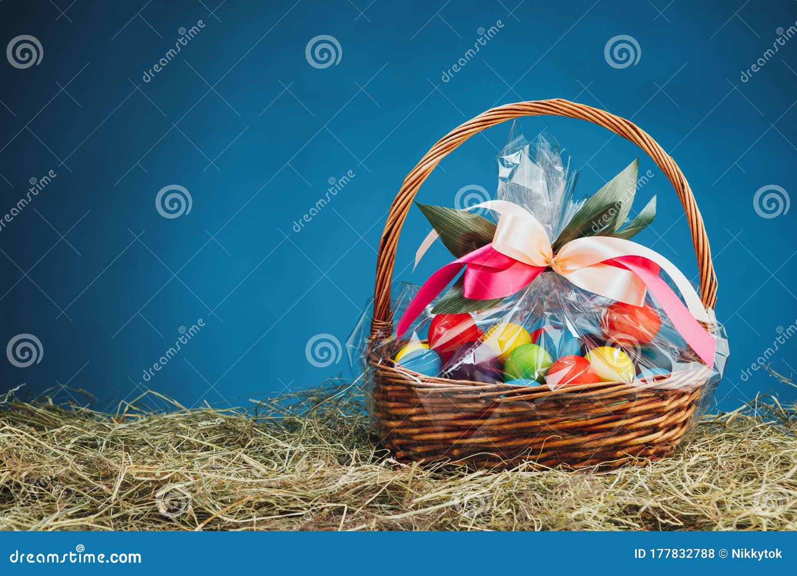 Easter Gift Basket with Multicolor Eggs, Blue Background Stock Photo ...