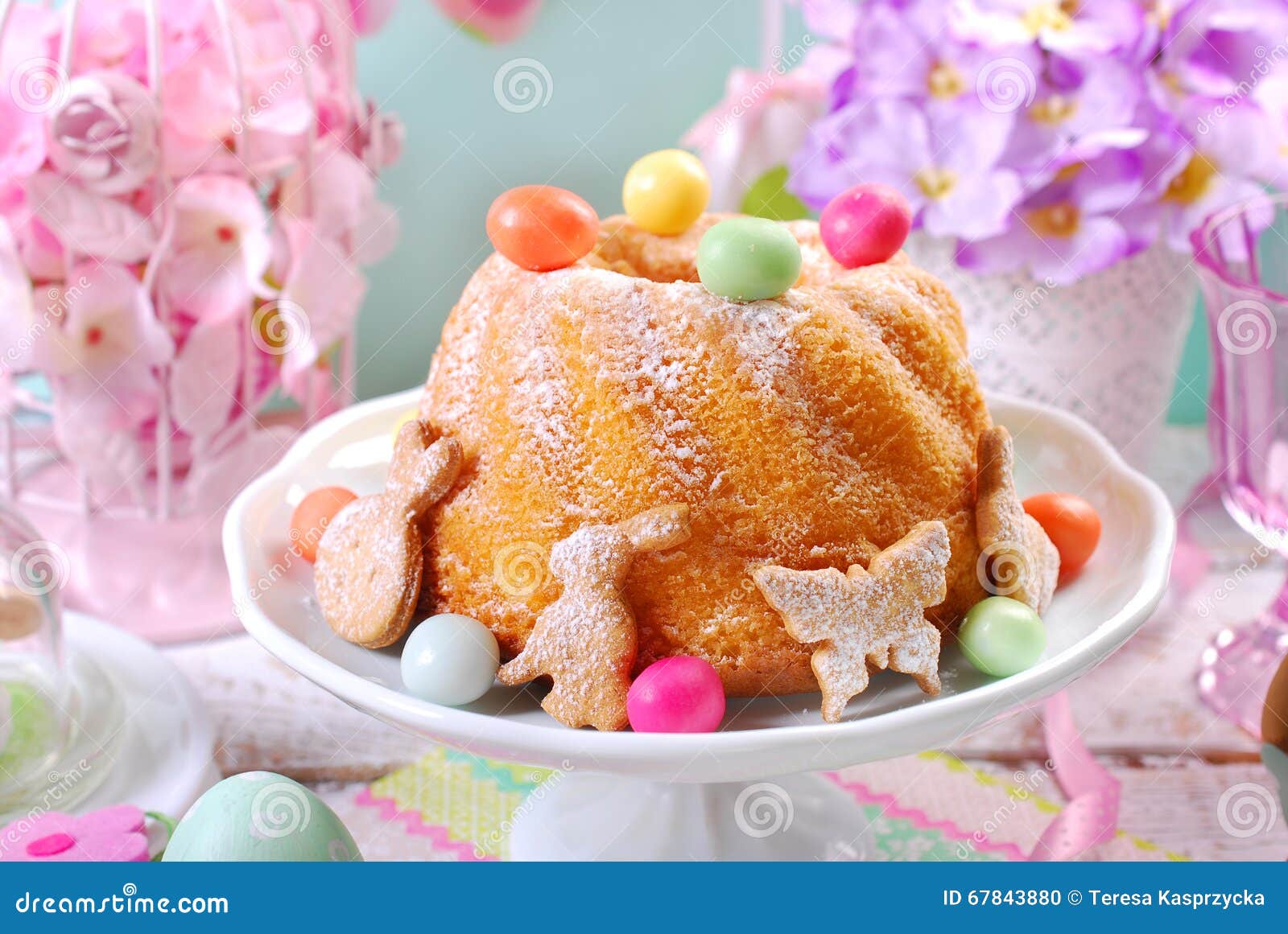 Easter Ring Cake with Candy Eggs and Cookies on Spring Table Stock ...