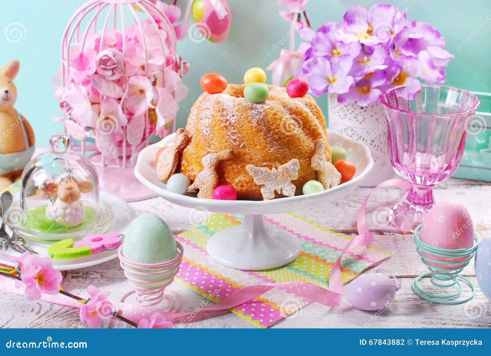 Easter Ring Cake with Candy Eggs and Cookies on Spring Table Stock ...