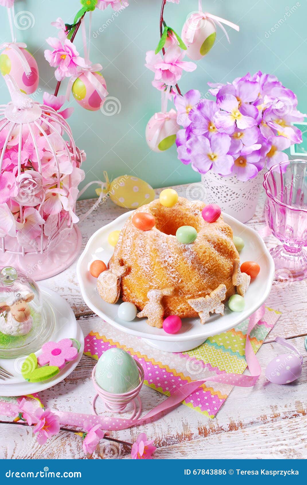Easter Ring Cake with Candy Eggs and Cookies on Spring Table Stock ...