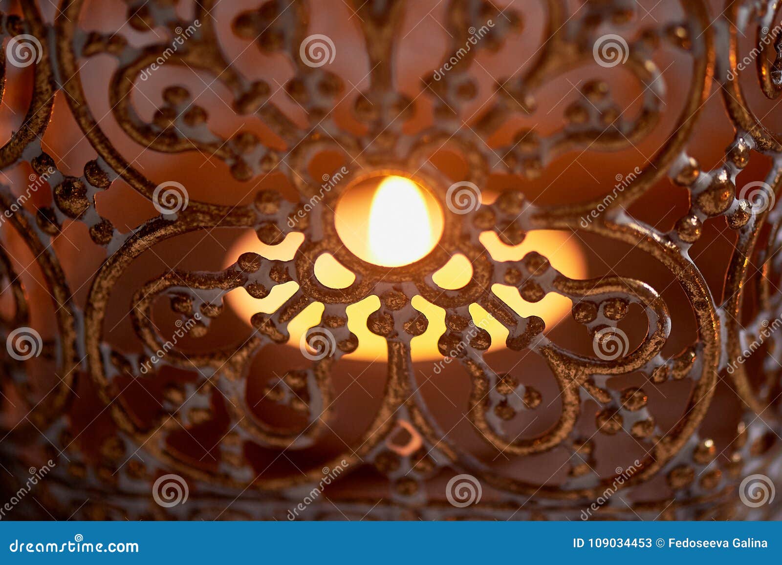 Eastern Candlesticks with Patterns in Gold Leaf with a Burning Candle ...