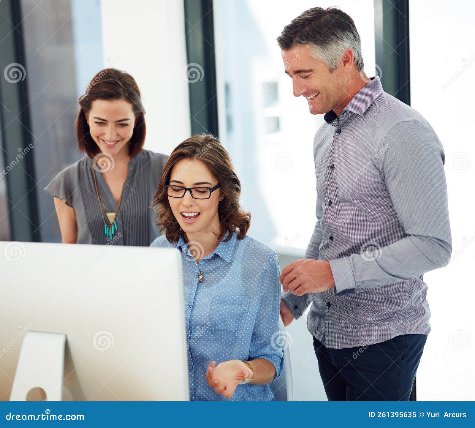 Is it really that Easy. Group of Colleagues Using a Computer Together ...
