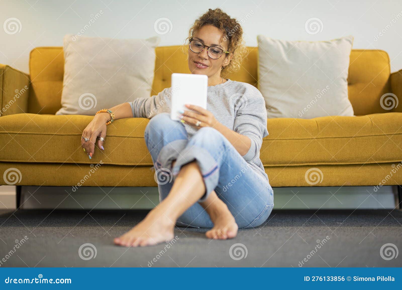 Easy Relaxed Lady at Home Reading and Using Tablet Ereader Ebook Device ...