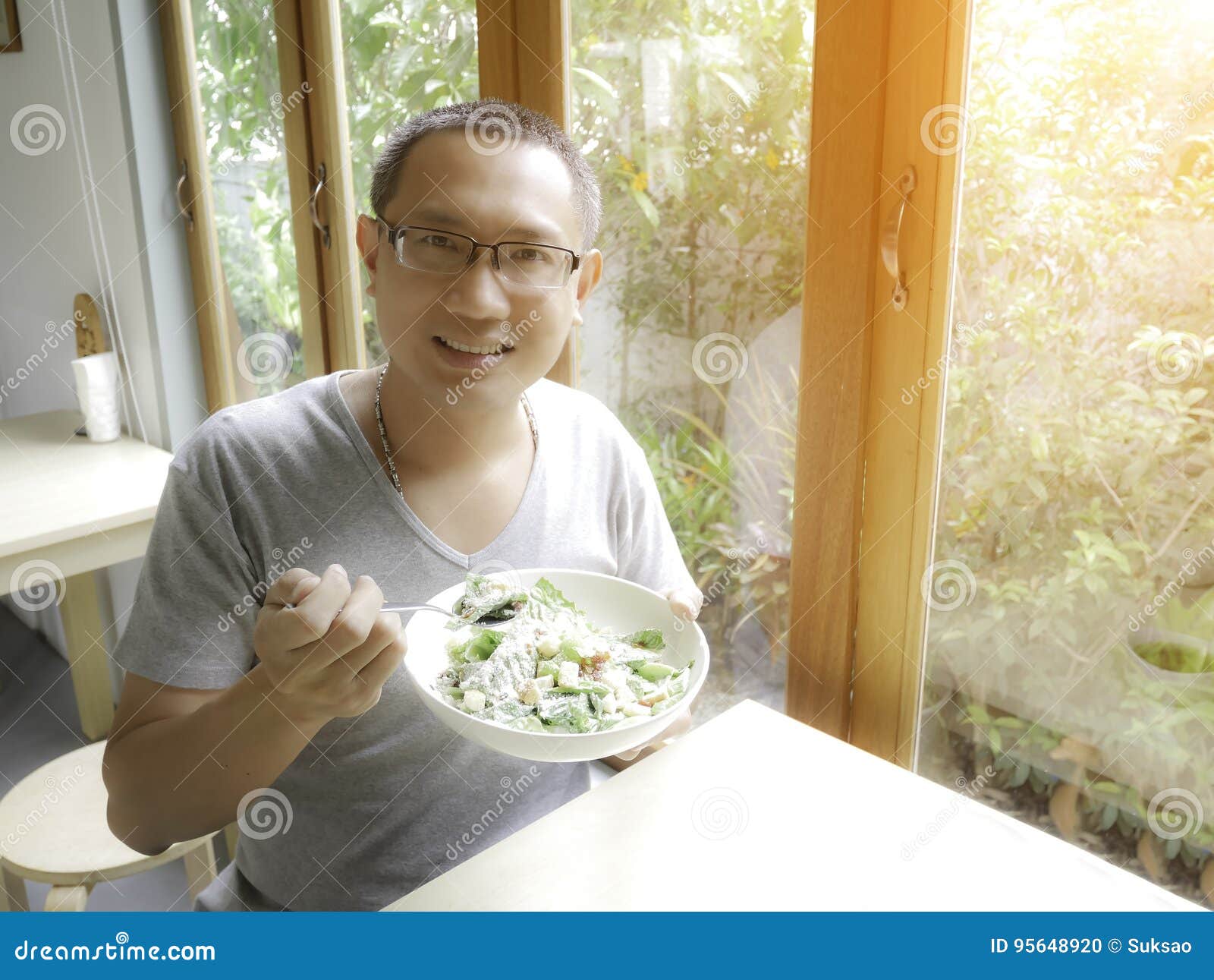 Eating caesar salad stock photo. Image of dressing, male - 95648920