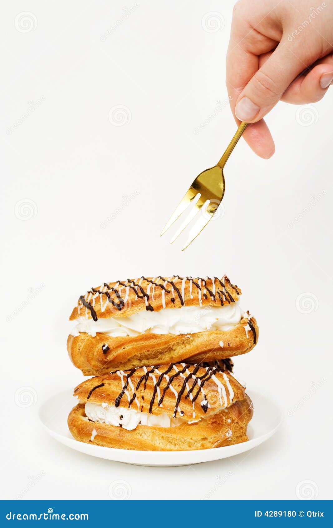 Eating eclair. stock photo. Image of fork, yummy, hand - 4289180