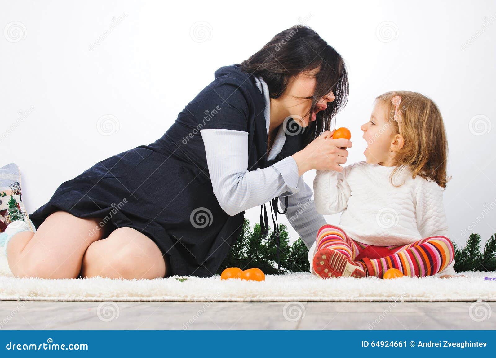 Eating Mandarin Together stock image. Image of face, family - 64924661