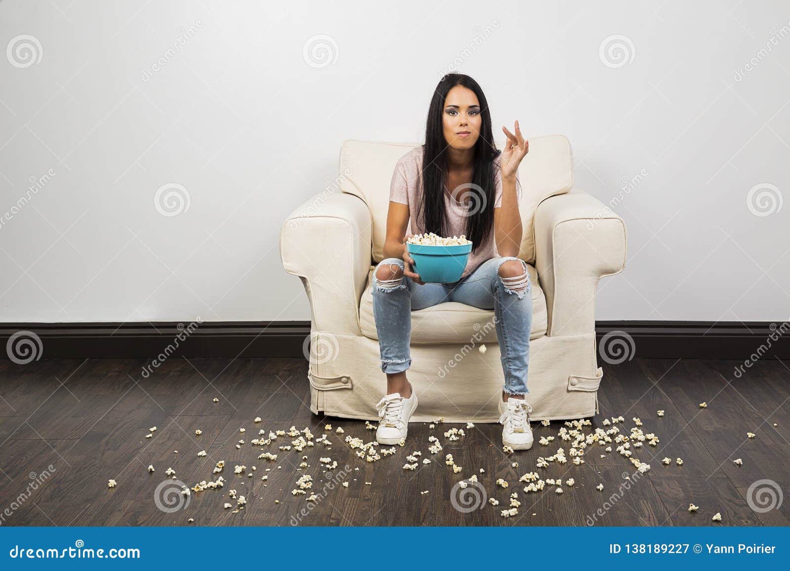 Eating popcorn on a couch stock image. Image of happy - 138189227