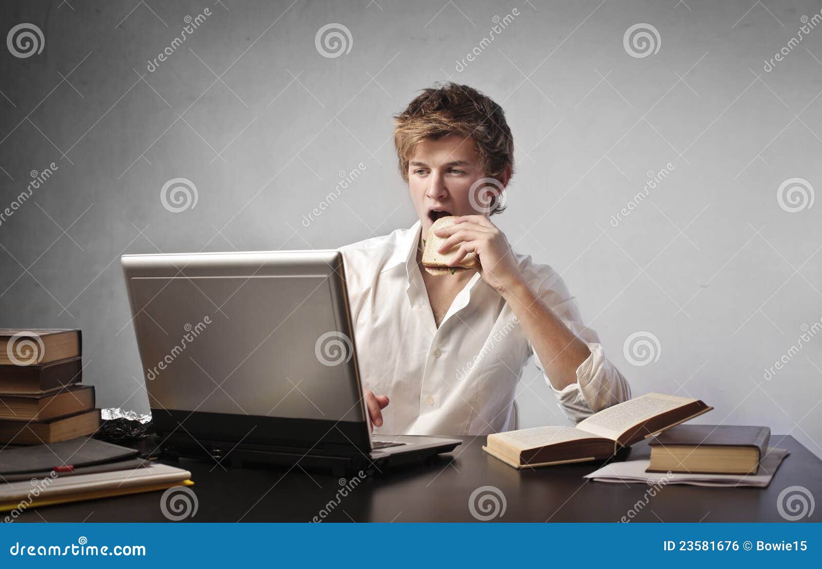 Eating while studying stock photo. Image of work, face - 23581676