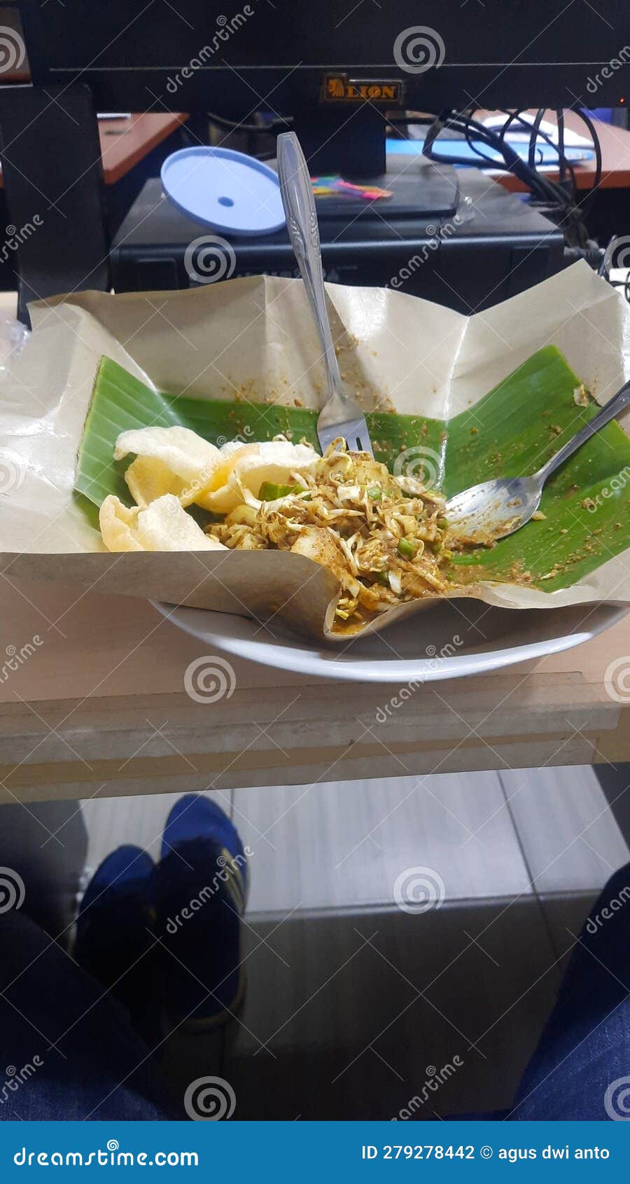 Eating Traditional Pecel Rice from Java in Front of a Computer during ...