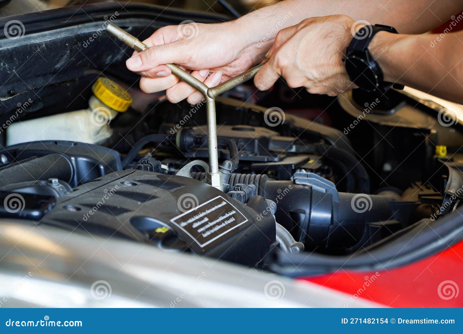 Mechanic Works on the Engine of the Car in the Garage. Repair Service ...