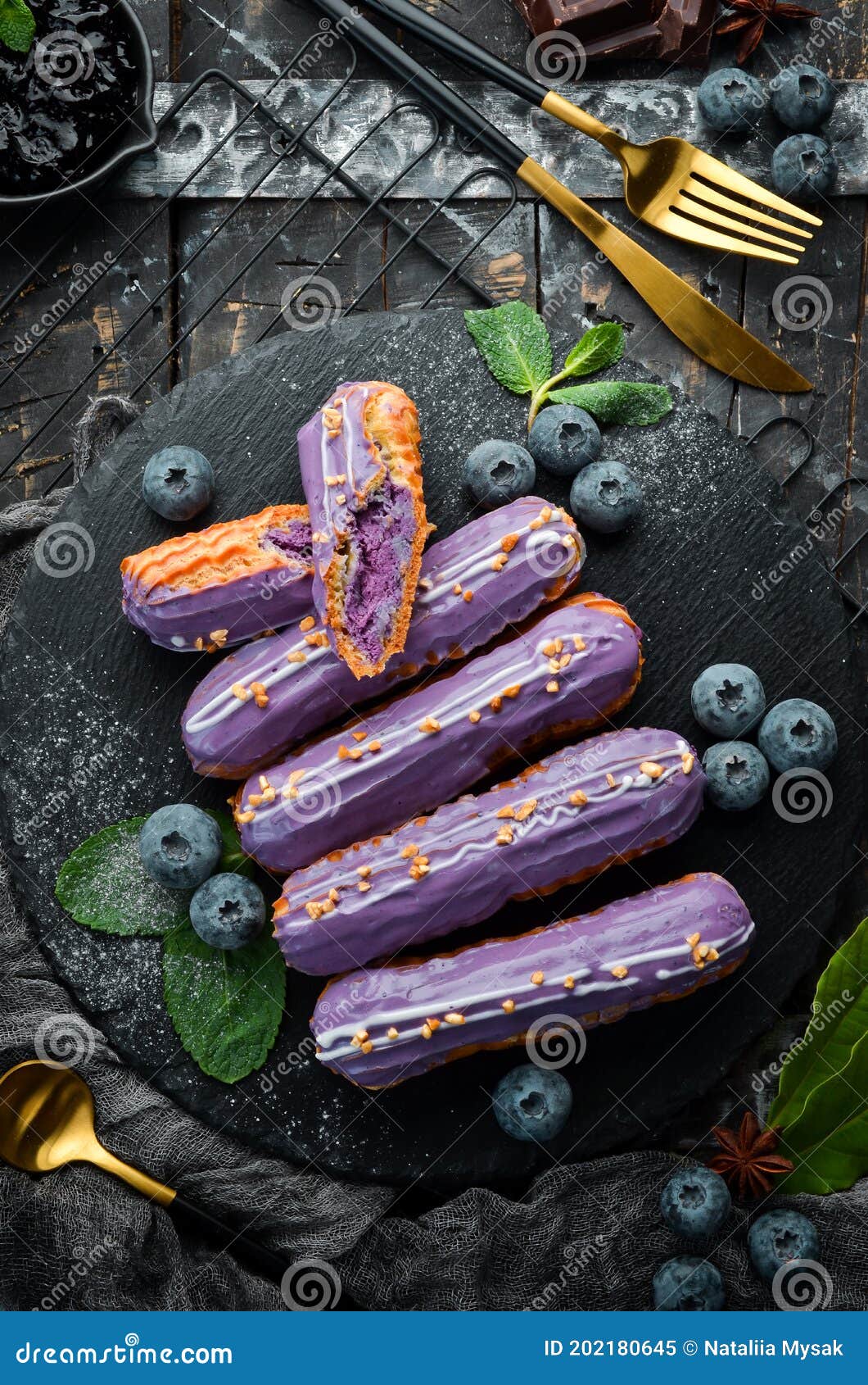 Eclair with Blueberry Cream. Blueberry Dessert on a Black Stone Plate ...
