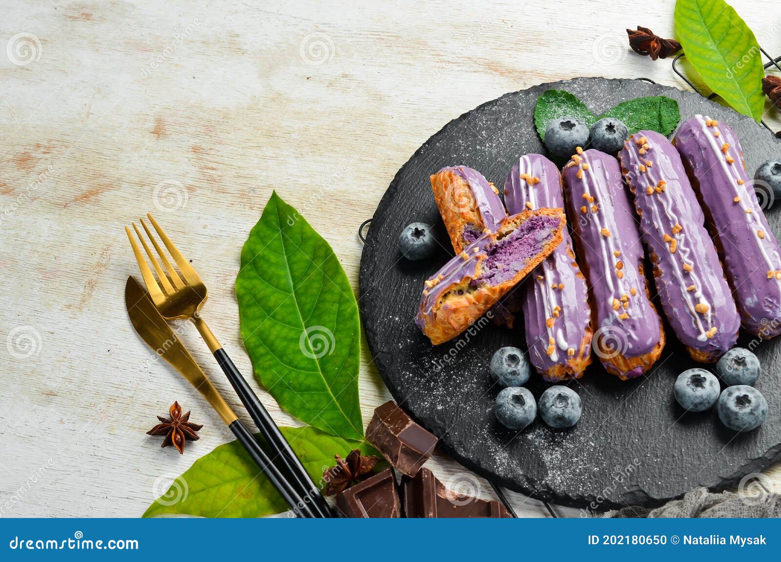 Eclair with Blueberry Cream. Blueberry Dessert on a Black Stone Plate ...