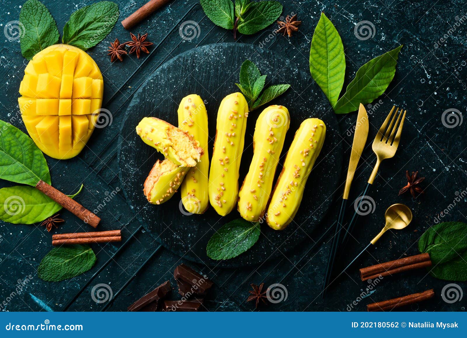 Eclair with Mango Cream. Mango Dessert on a Black Stone Plate. Top View ...