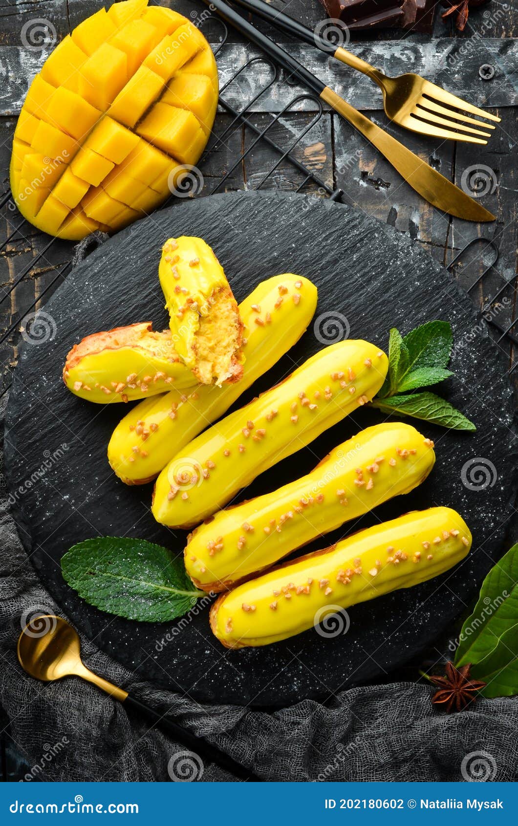 Eclair with Mango Cream. Mango Dessert on a Black Stone Plate. Top View ...