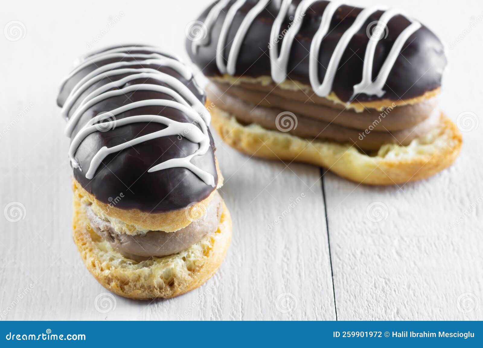 Eclairs with Black Chocolate and White Chocolate with Custard on Rustic ...