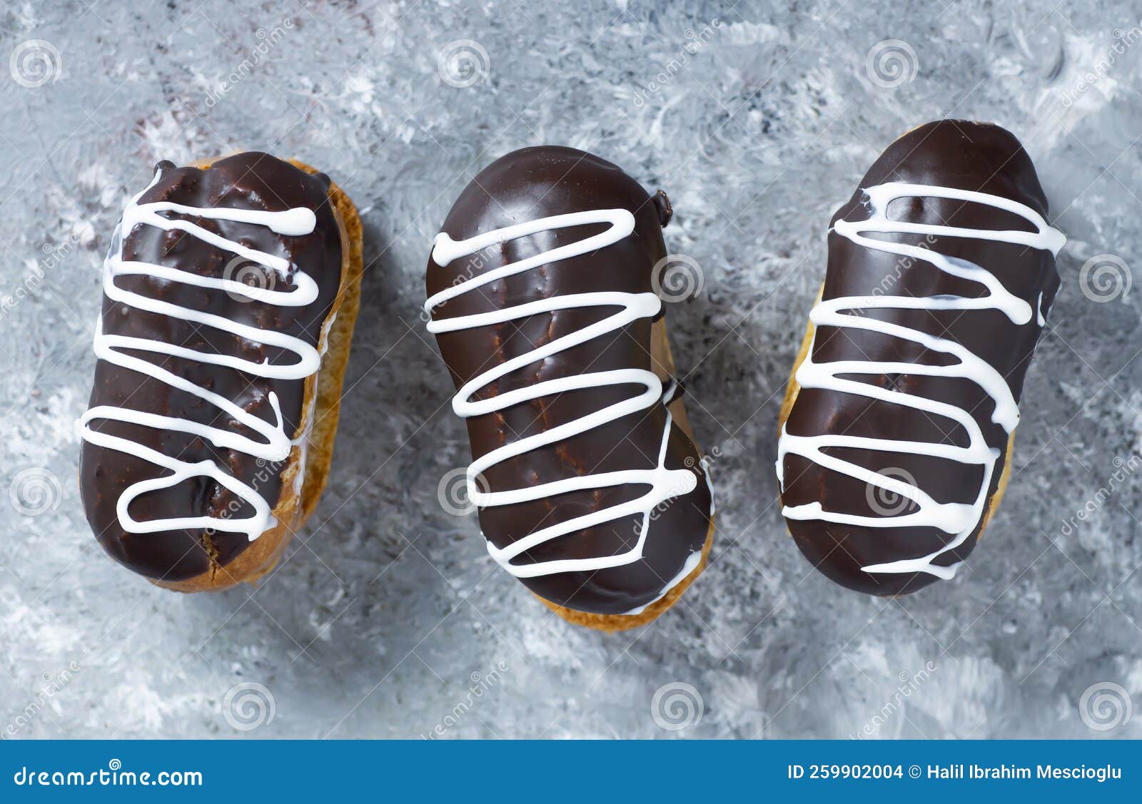 Eclairs with Black Chocolate and White Chocolate with Custard on Rustic ...