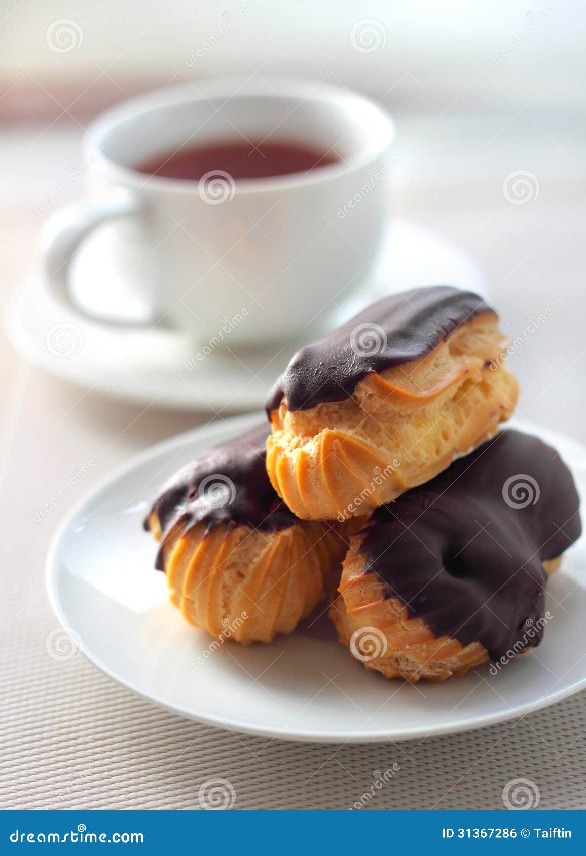 Eclairs with Cream in Chocolate Coating Stock Photo - Image of color ...
