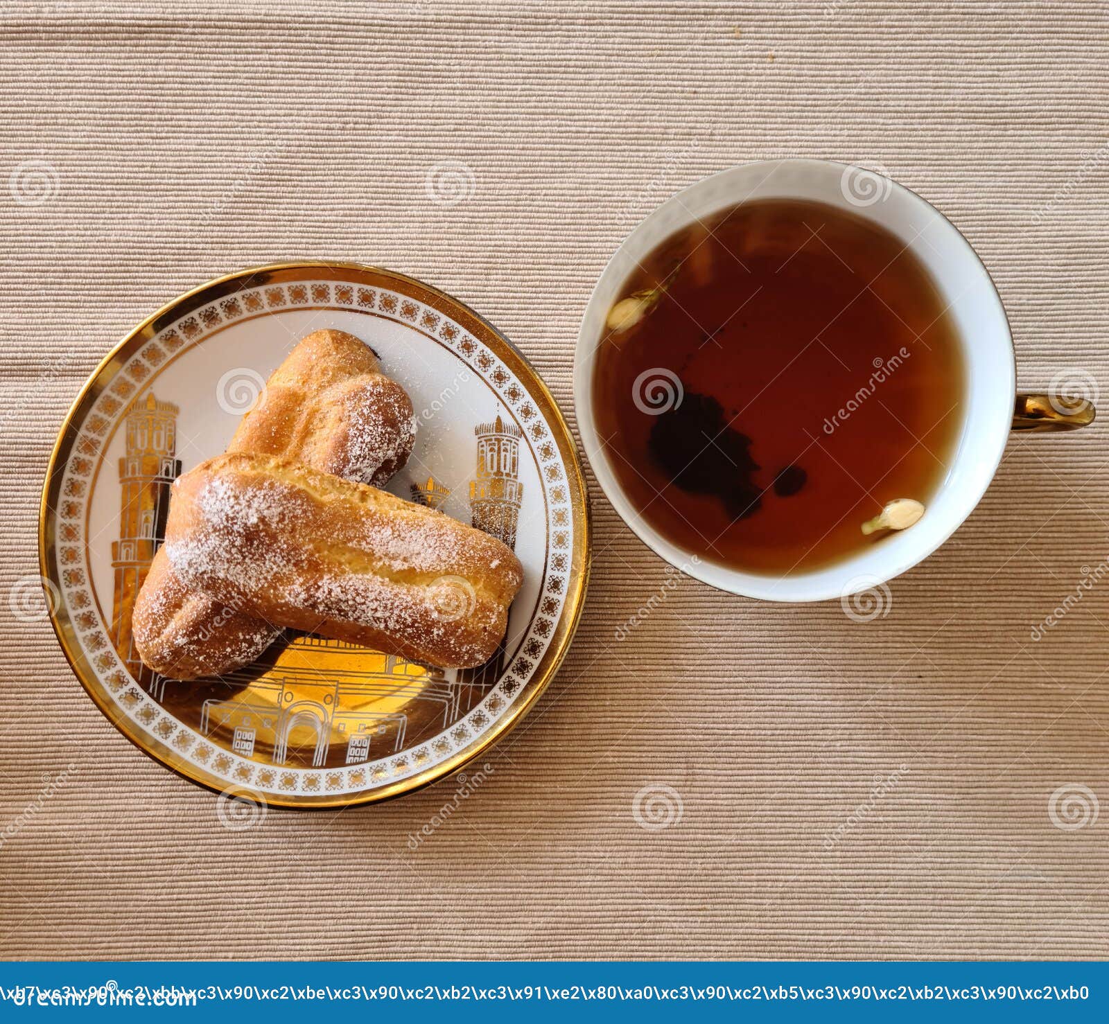 Eclairs and a cup of tea stock photo. Image of plate - 218944392