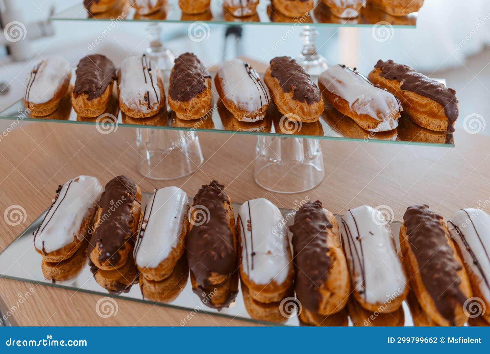 Eclairs with White and Chocolate Icing are Laid Out in a Row on a ...