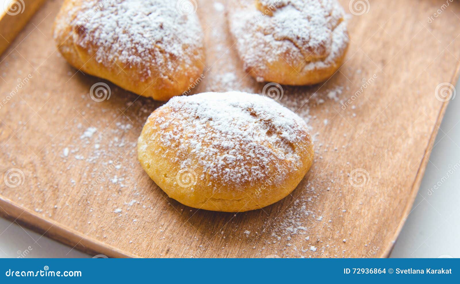 Eclairs on a wooden board stock photo. Image of powdered - 72936864