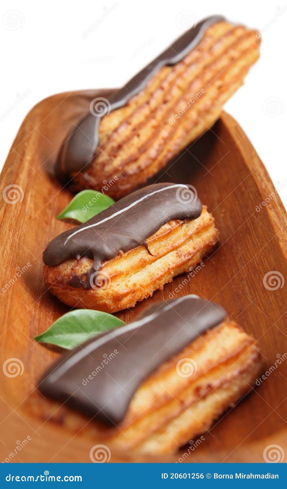 Eclairs on wooden plate stock photo. Image of choux, cookies - 20601256