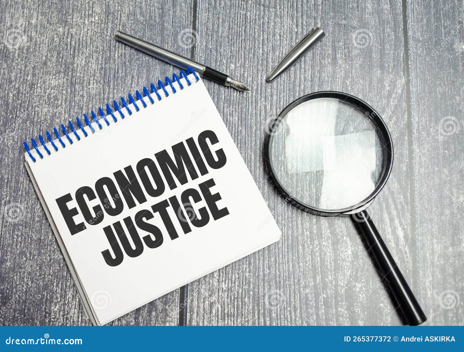 Economic Justice Words on White Notebook and Pen with Magnifying Glass ...