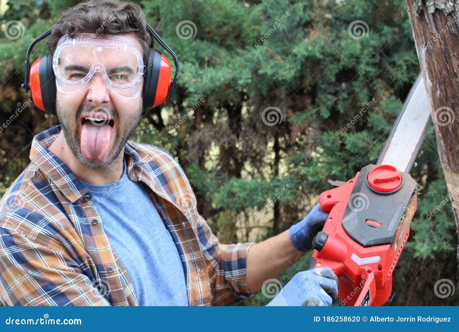 Ecstatic Young Man Holding a Chainsaw Stock Photo - Image of male ...