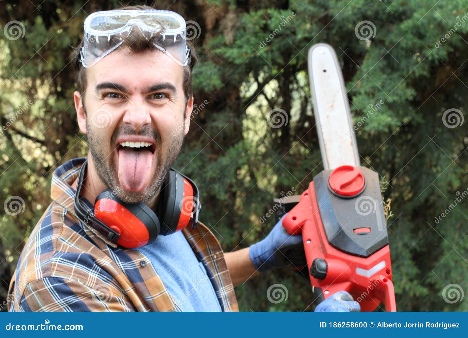 Ecstatic Young Man Holding a Chainsaw Stock Photo - Image of nature ...