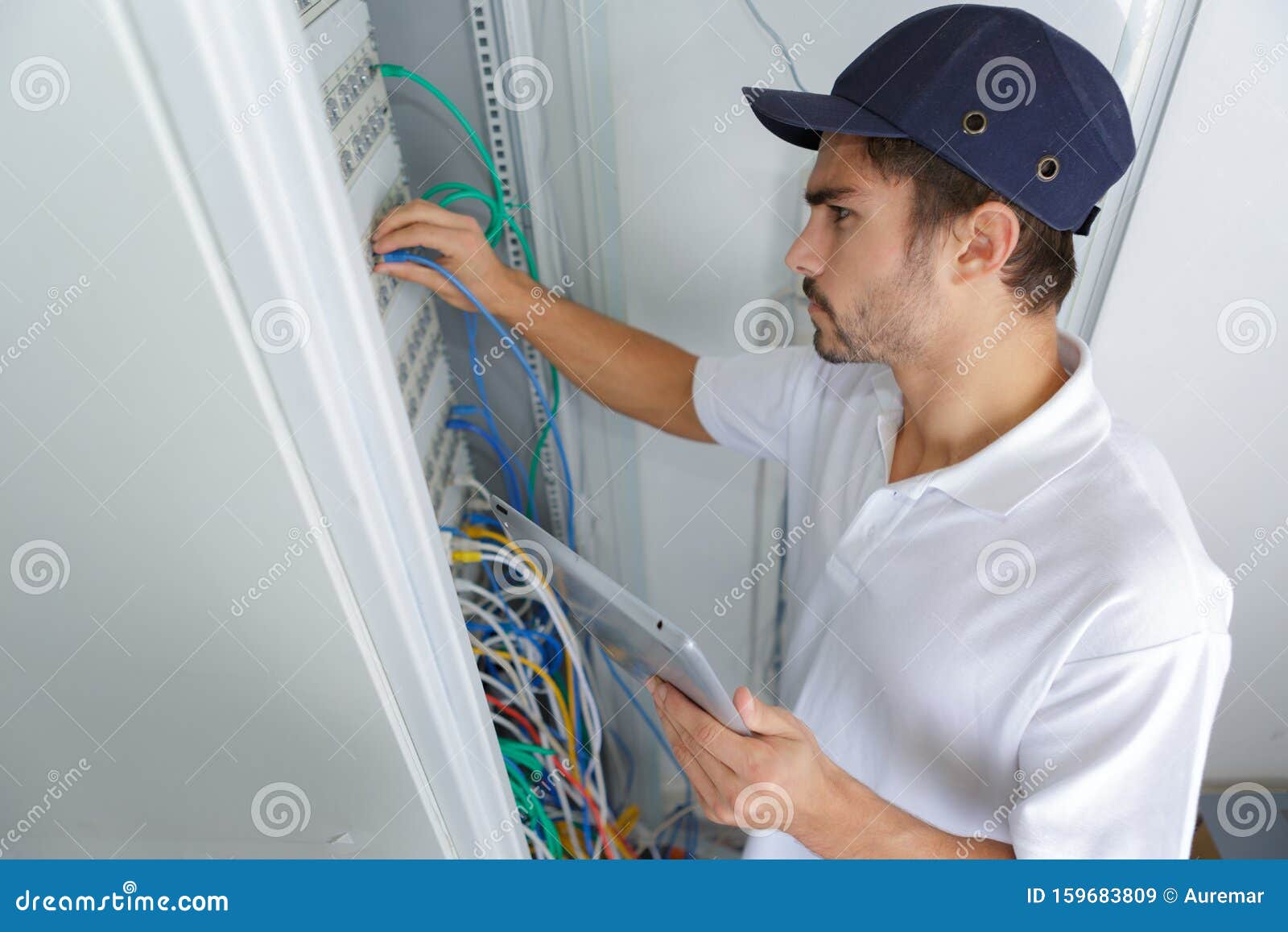 Focused Electrician Applying Safety Procedure while Working on ...