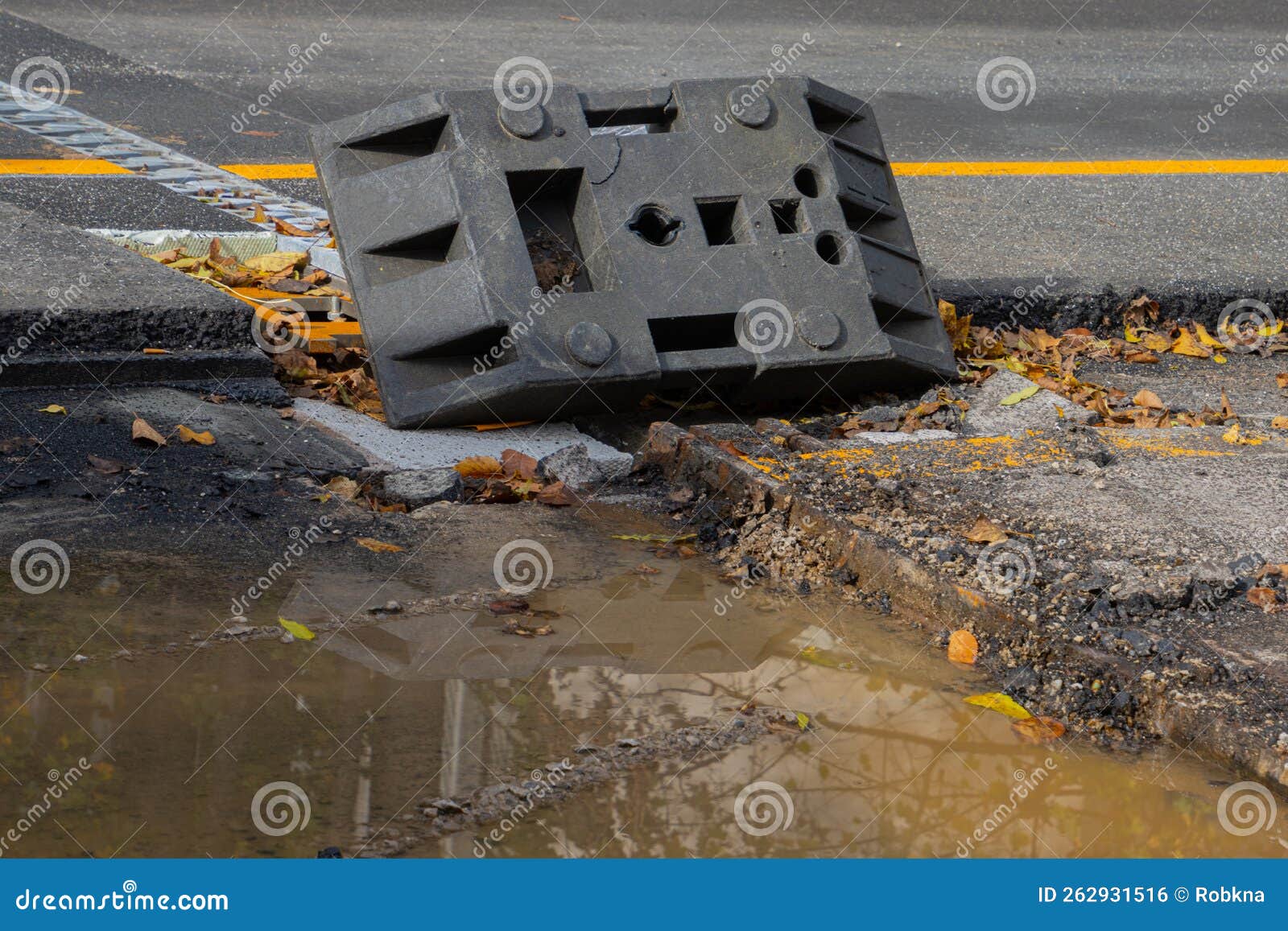 Edge of Milled Asphalt Road Patch and a Water Puddle at a Construction ...