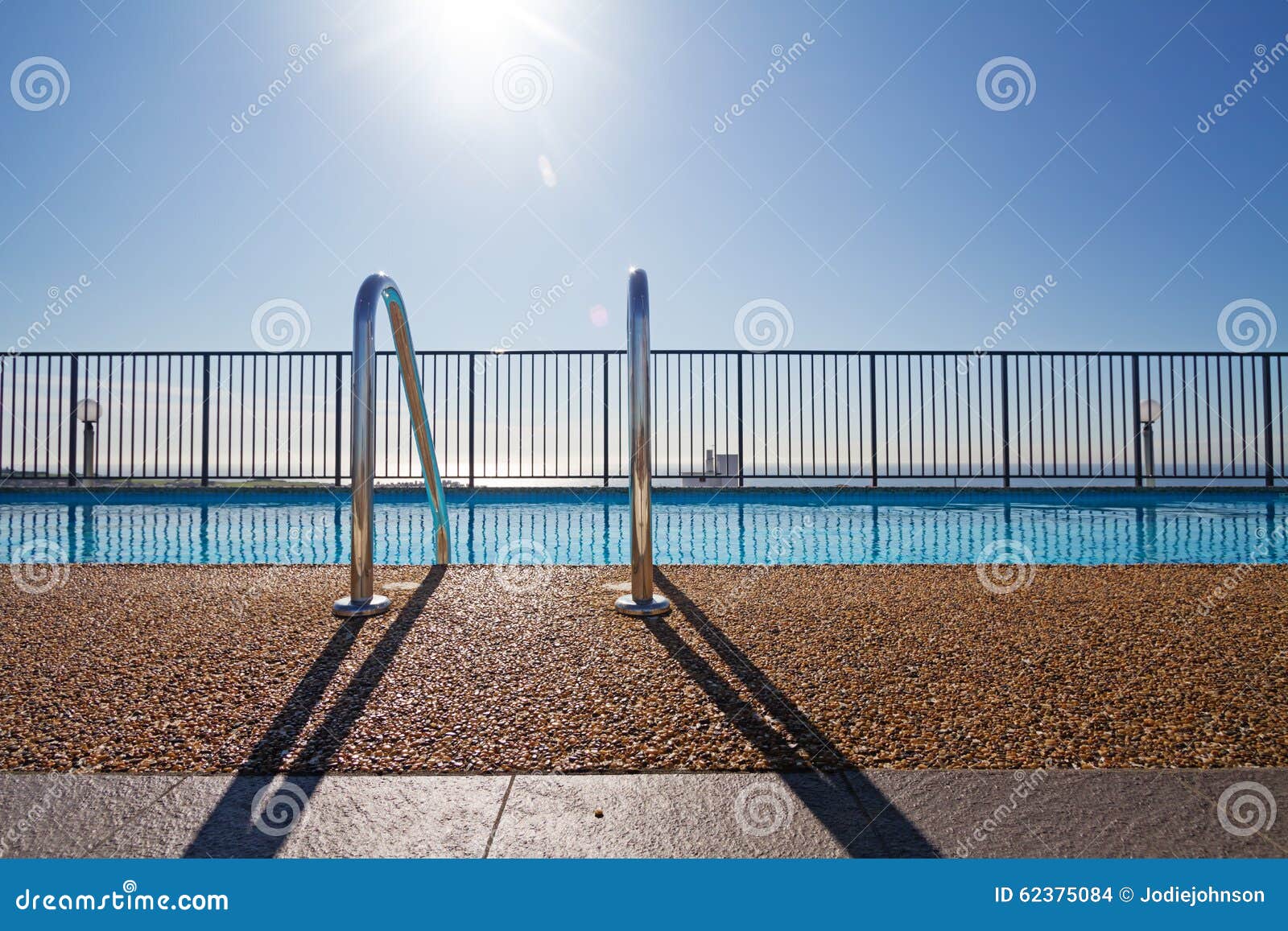 Edge of Swimming Pool with Sun Flare in Background Stock Photo - Image ...