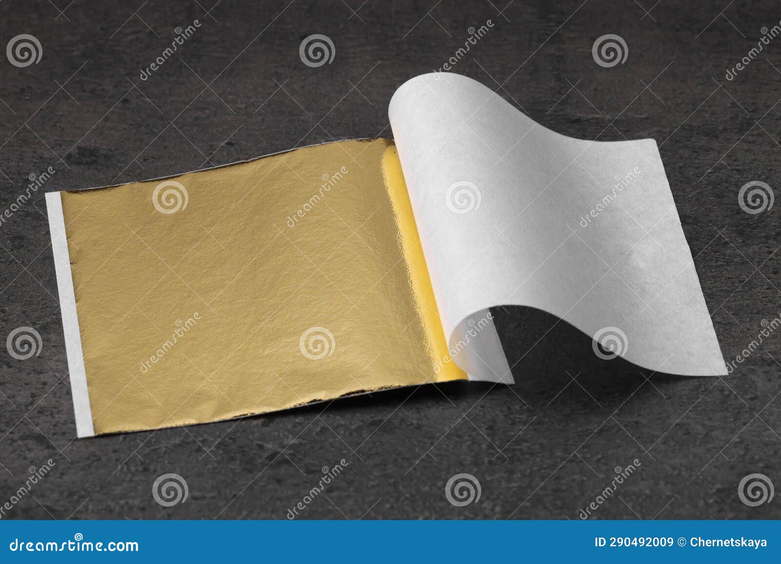 Edible Gold Leaf Sheet on Textured Table, Closeup Stock Image - Image ...