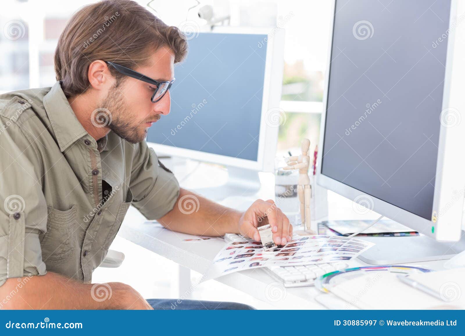 Editor Using Magnifying Loupe To Look at Contact Sheet Stock Image ...