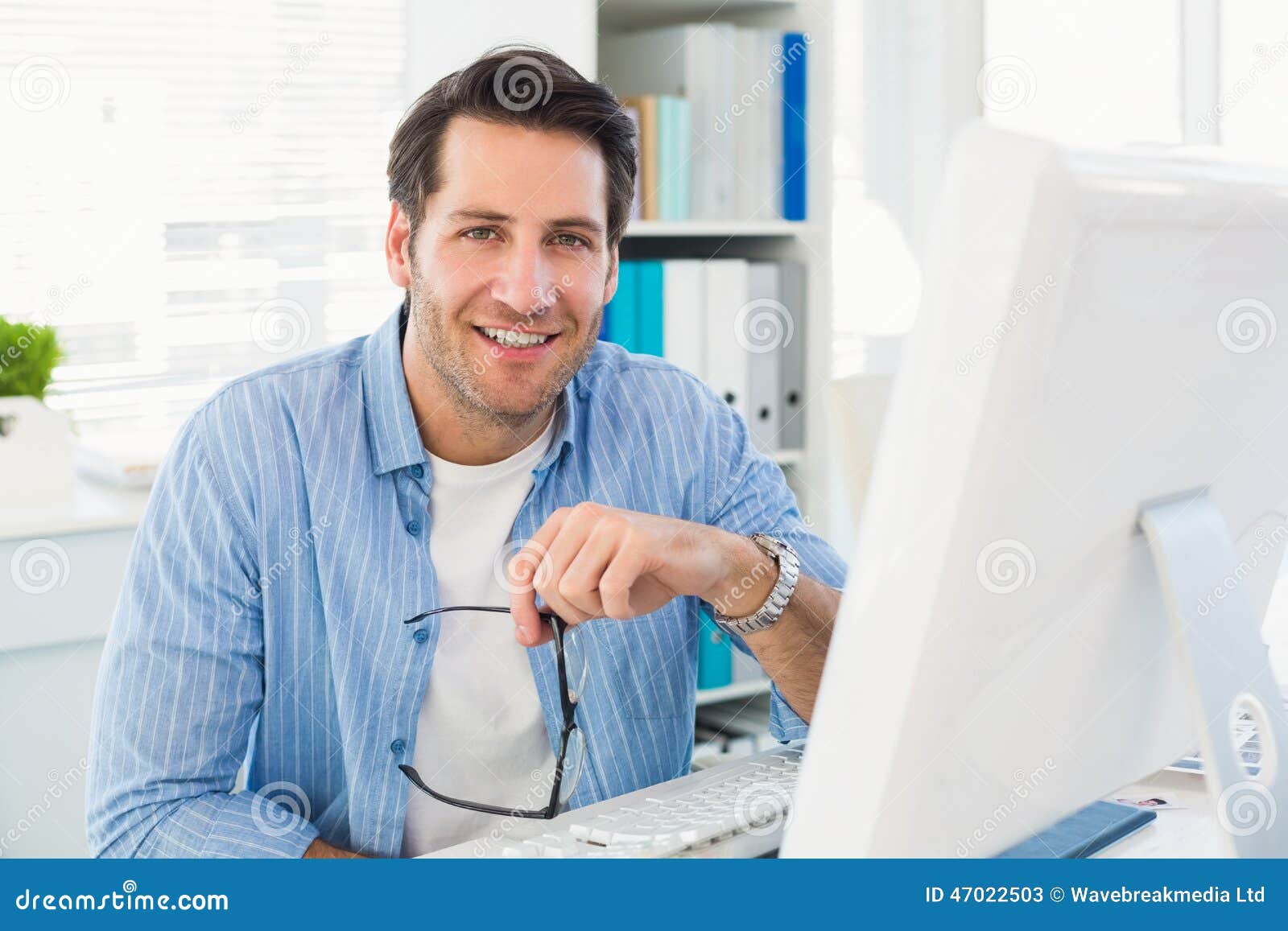 Editor Working at His Computer while Looking at Camera Stock Image ...