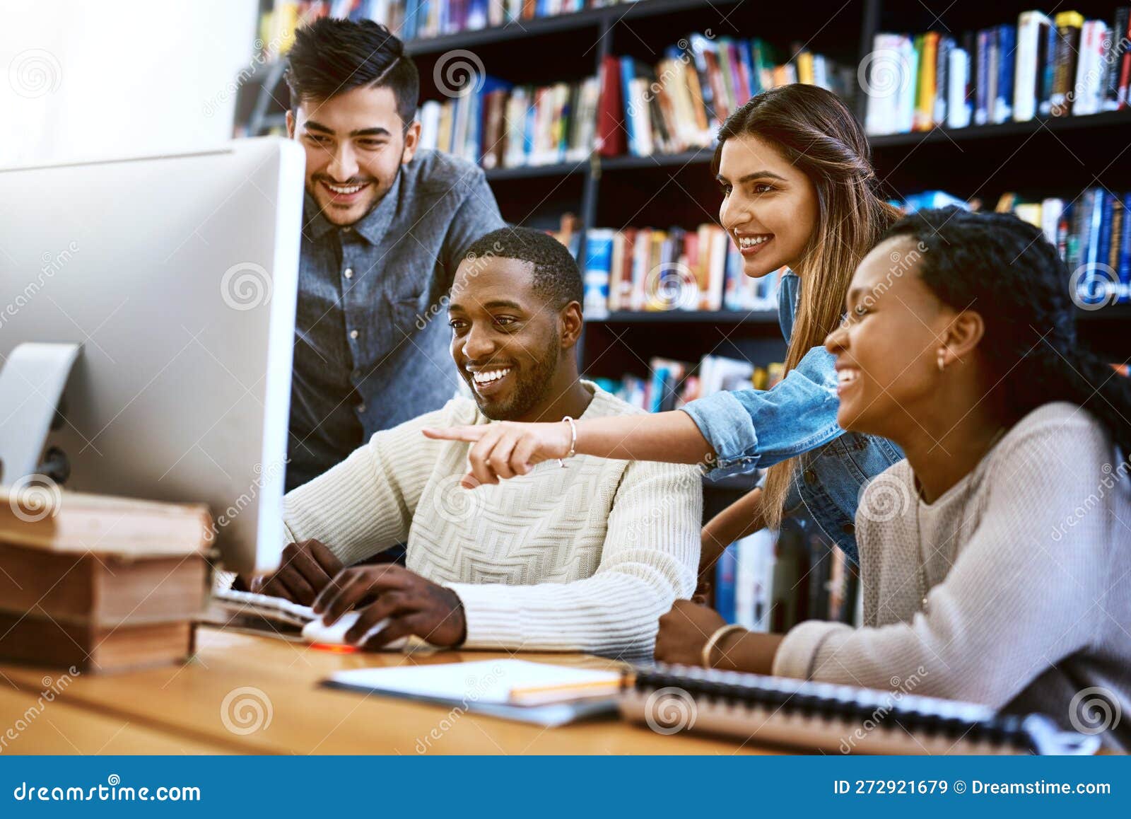 Education in Action. a Group of Young Students Using a Computer ...