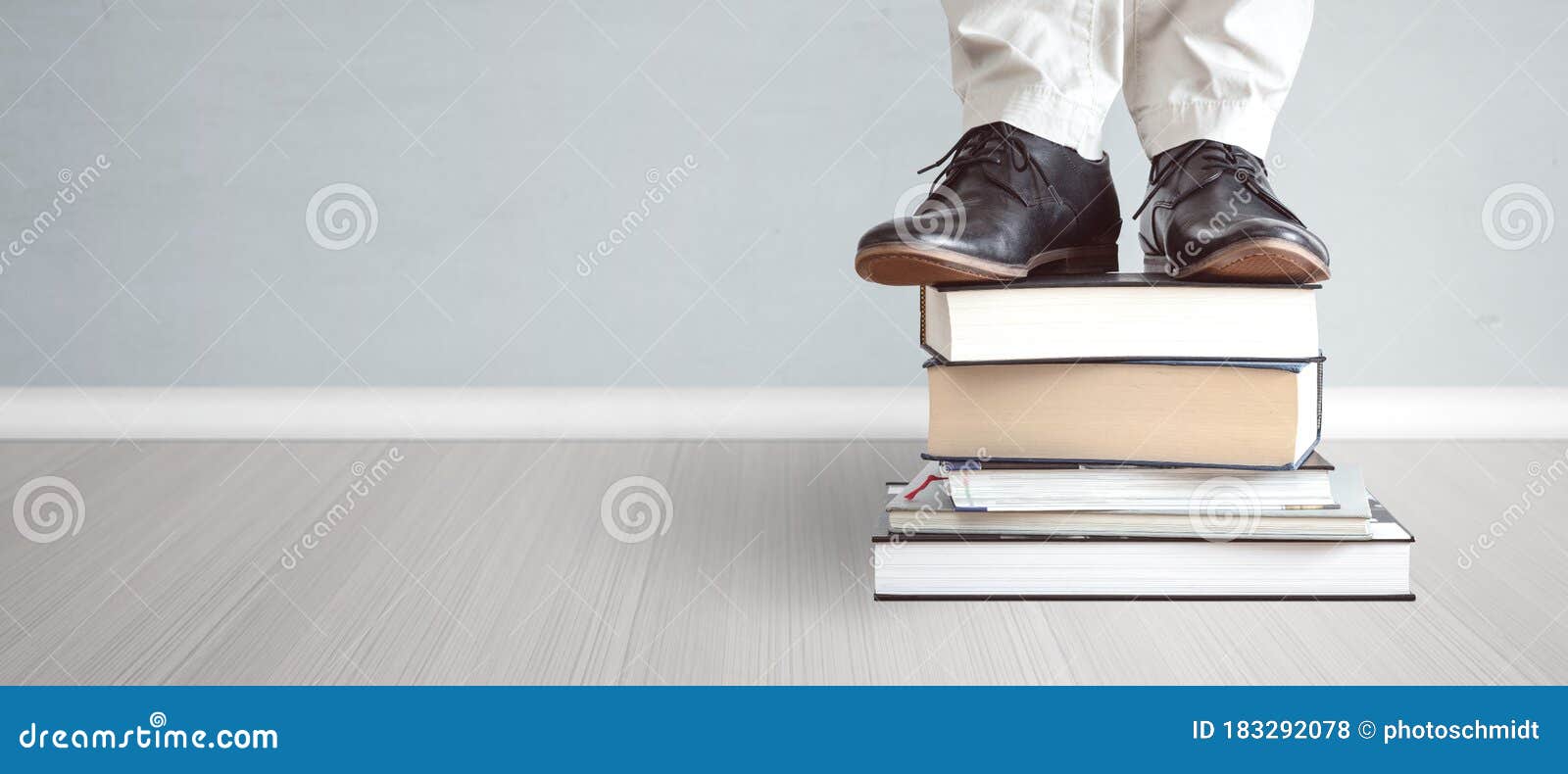 Education Concept - Feet Standing on a Stack of Books Stock Photo ...
