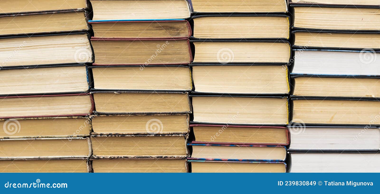 Books Stack on Wooden Table and Blurred Bookshelf in Library Hall ...