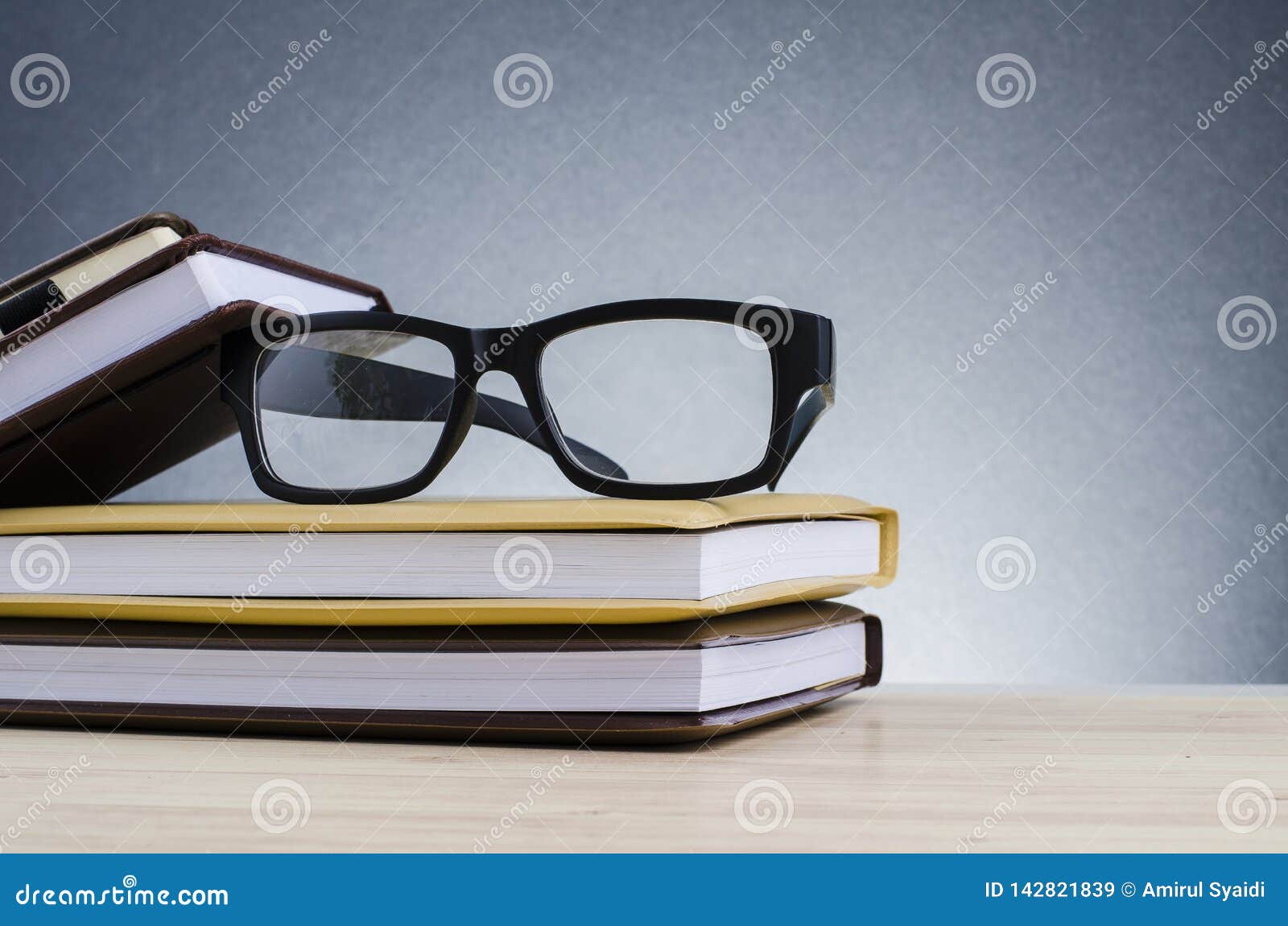 Spectacles on Stack of Books Over Beautiful Gradient Background with ...