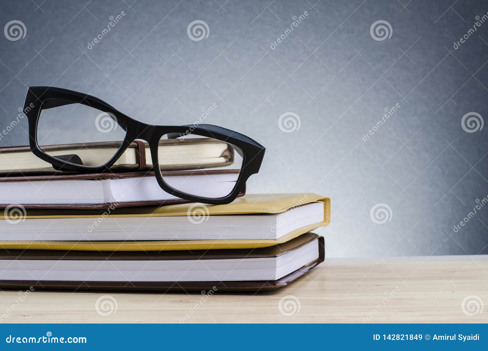 Spectacles on Stack of Books Over Beautiful Gradient Background with ...