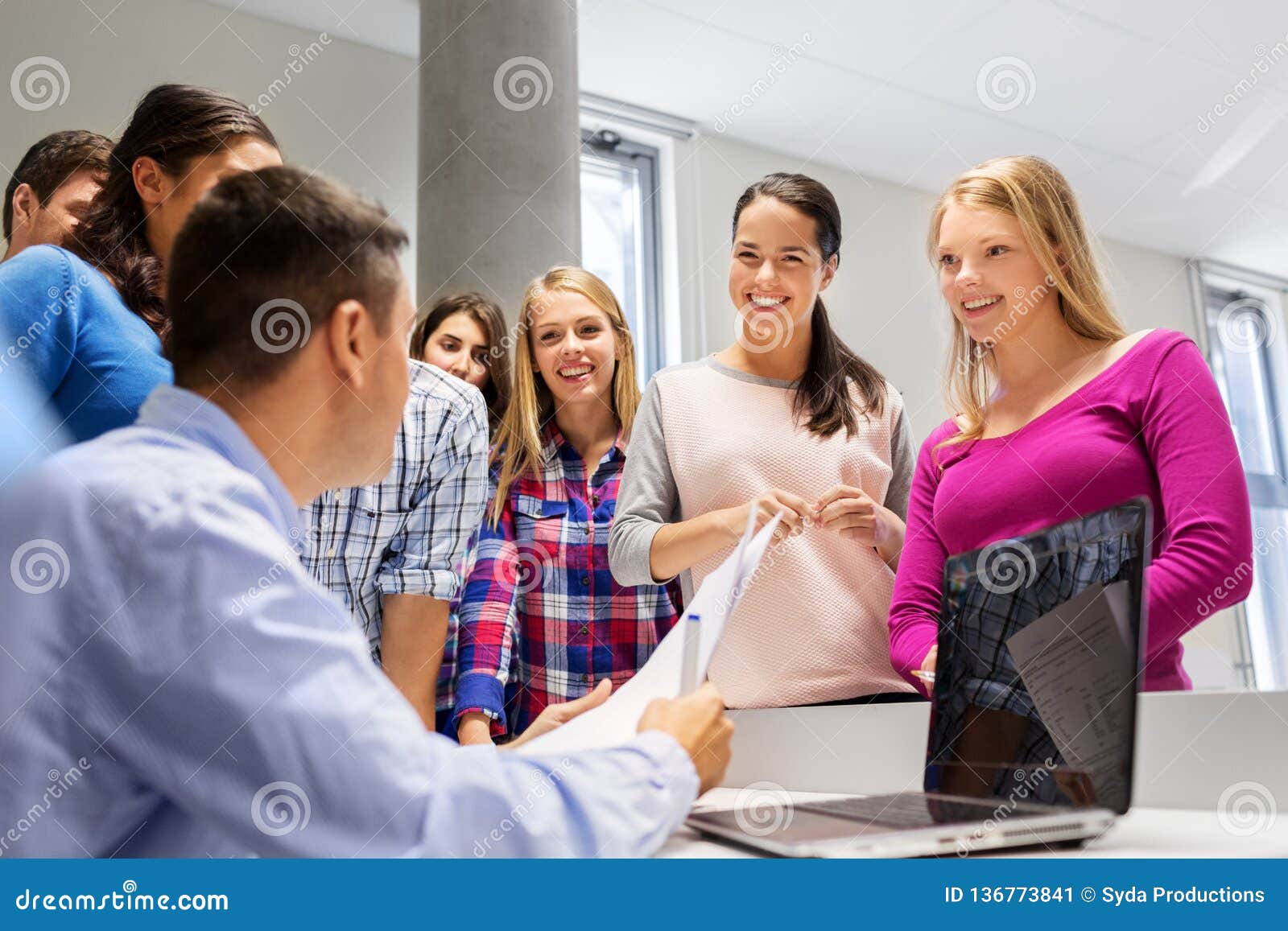 Students and Teacher with Papers and Laptop Stock Image - Image of ...