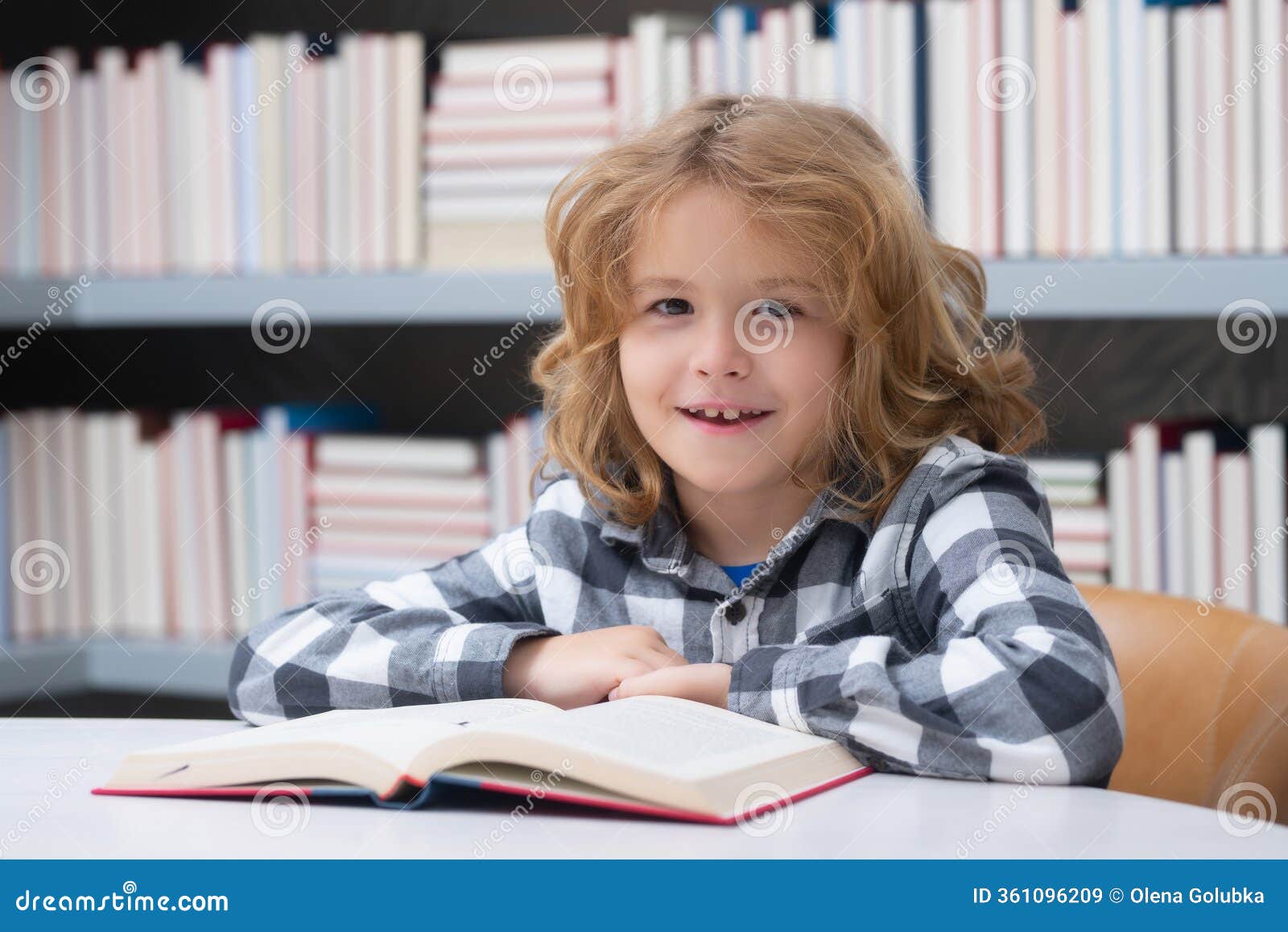 Education, Knowledge and Bookstore Concept. Kid Reading a Book in a School Library. School Boy ...