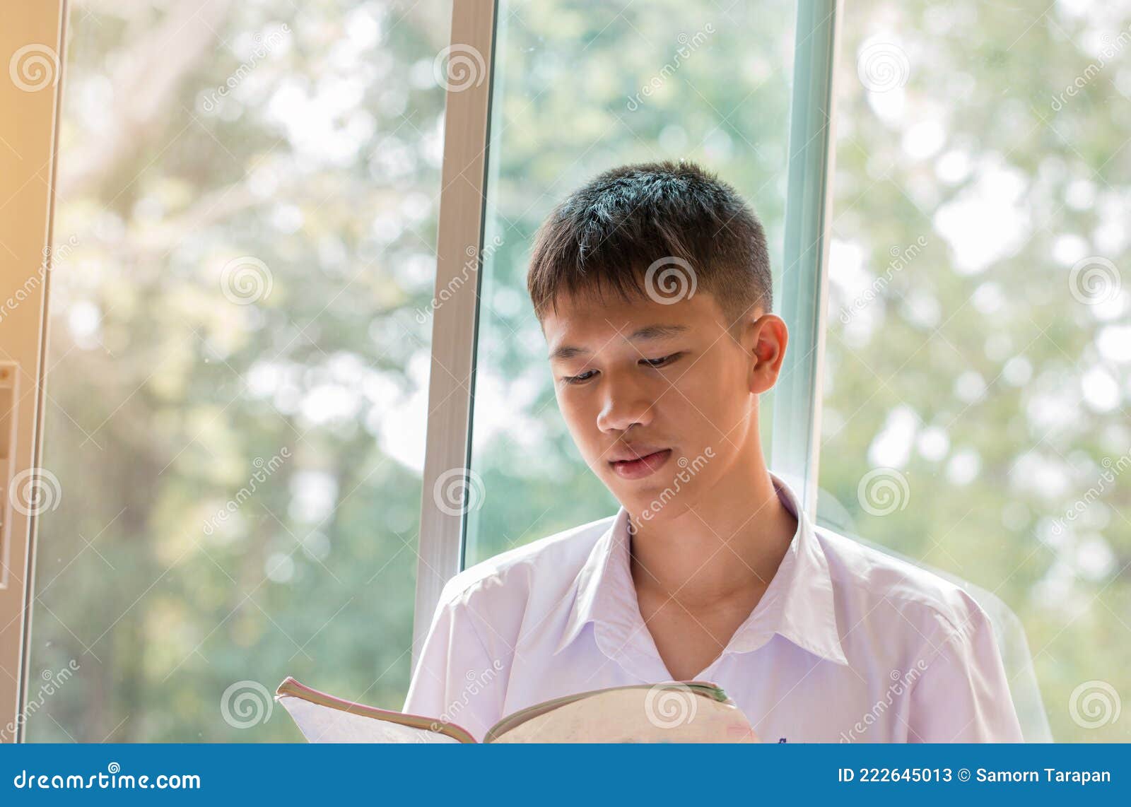 Education Learning Concept: Happy Asian Young Man Student Reading Book ...