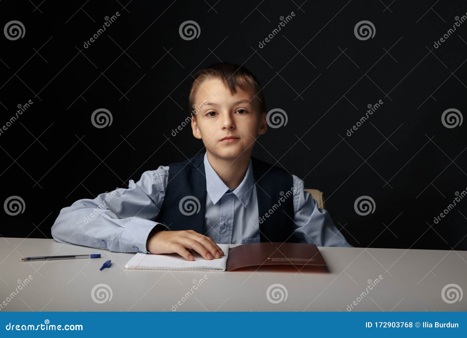 Education at School Concept. Boy Sitting at the Table and Studying ...