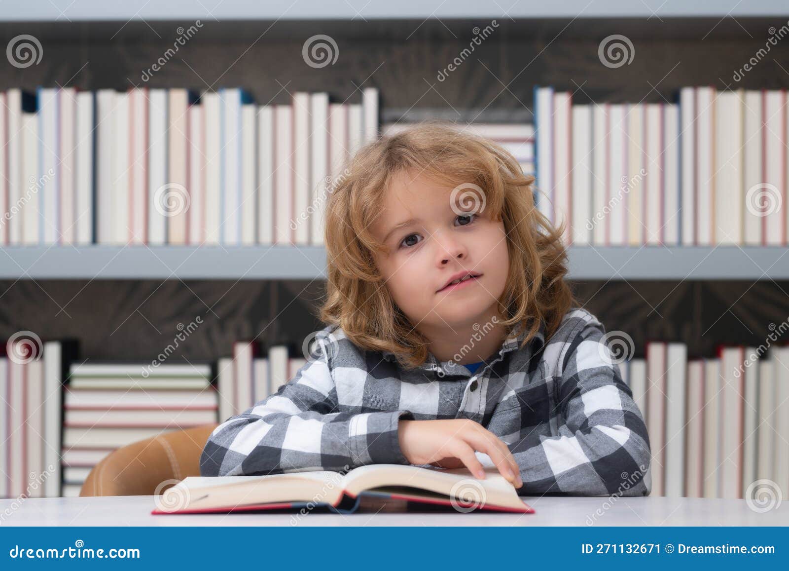 Education and School Concept. Child Reading a Book in a School Library ...